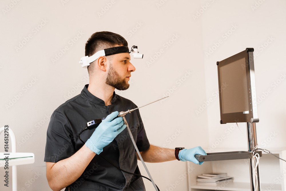 ENT doctor otolaryngologist with endoscope in hands. Prepearing for ...