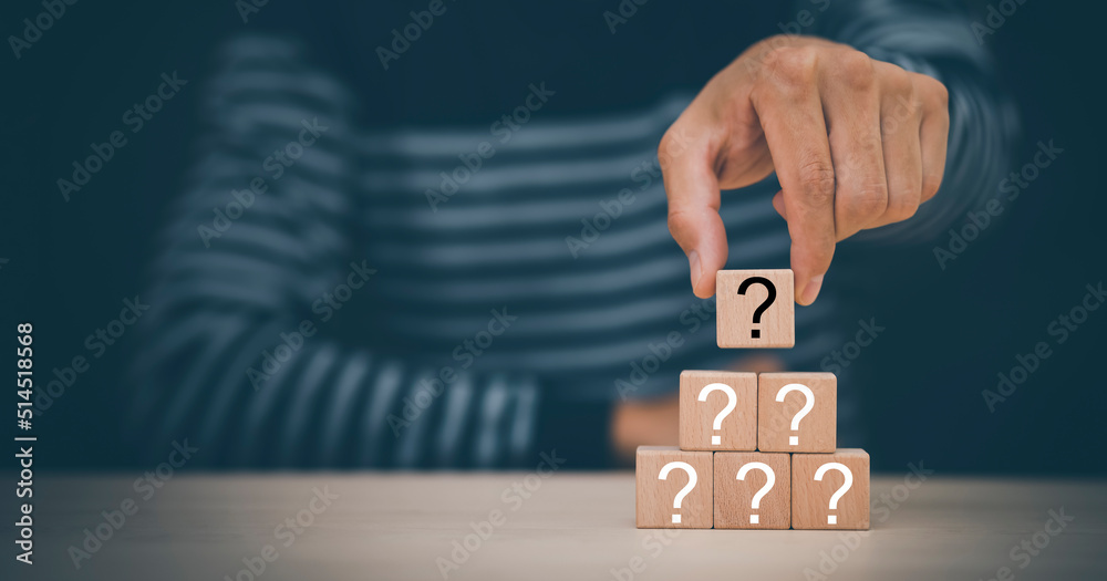 Hand hold Wooden cube block in question mark mean what on cement table ... Hand hold Wooden cube block in question mark mean what on cement table ...