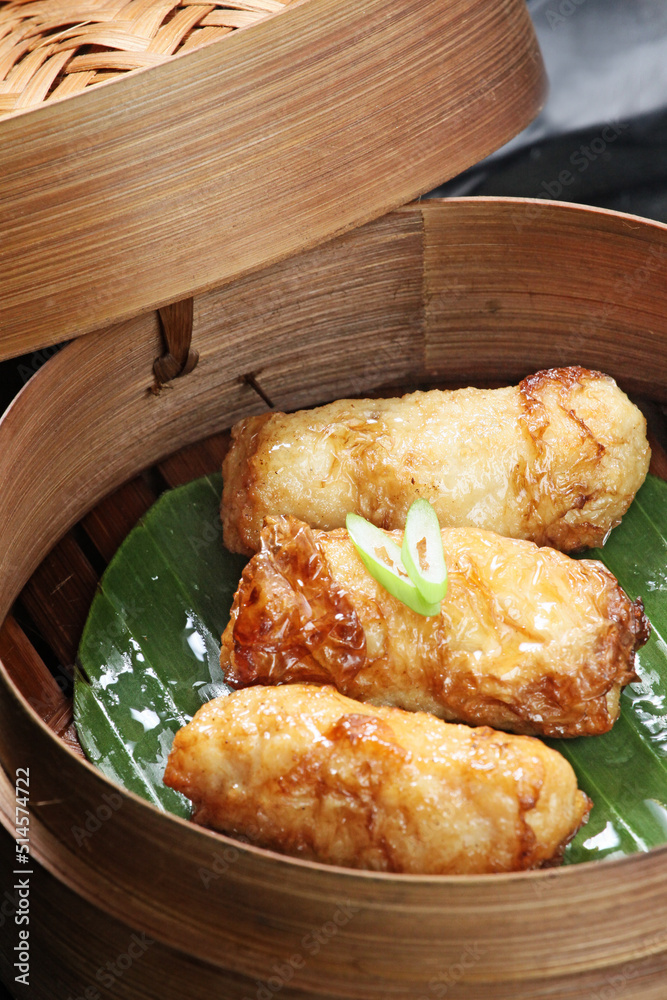 Crispy fried tofu skin dim sum with prawns and chicken served in a ...