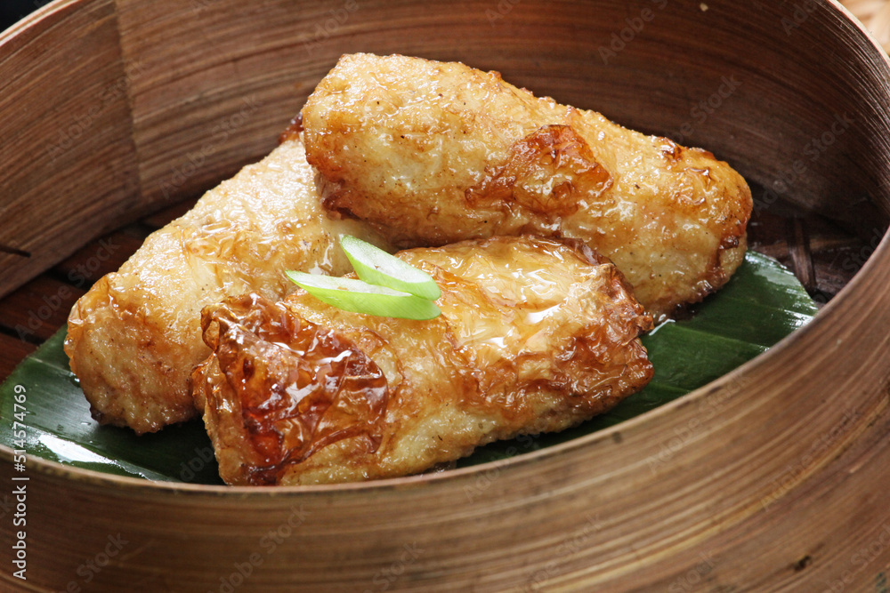 Crispy fried tofu skin dim sum with prawns and chicken served in a ...