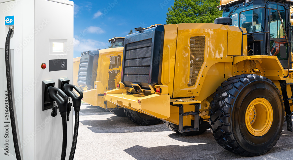 Electric construction machines with charging station. Concept Stock ...