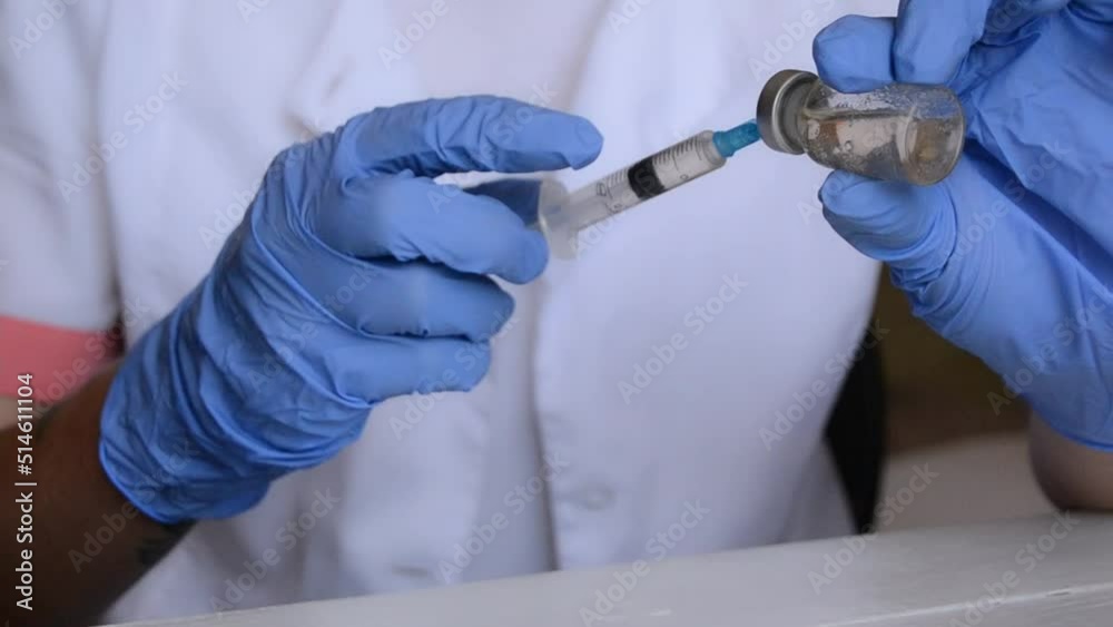 Closeup of a doctor filling a syringe with vaccines. Needle of the ...