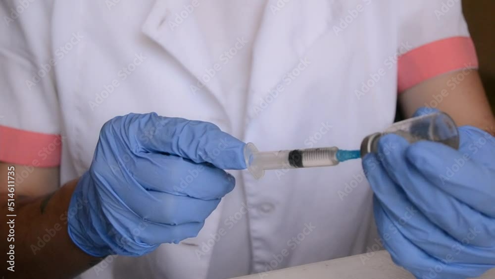 Closeup of a doctor filling a syringe with vaccines. Needle of the ...