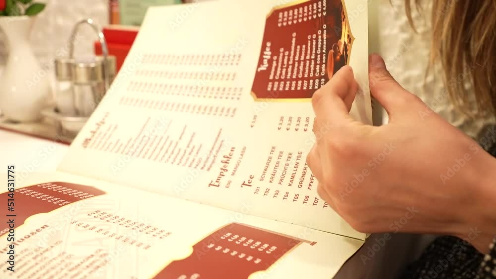 Flipping through the menu in a restaurant Stock Video | Adobe Stock