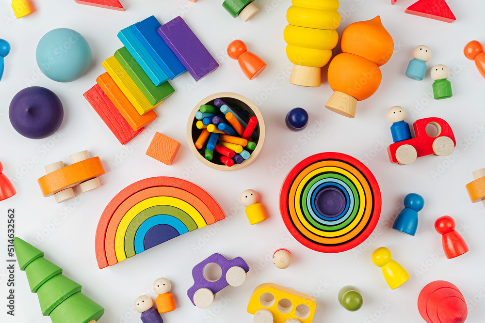Colorful wooden toys in the colors of the rainbow on white background ...