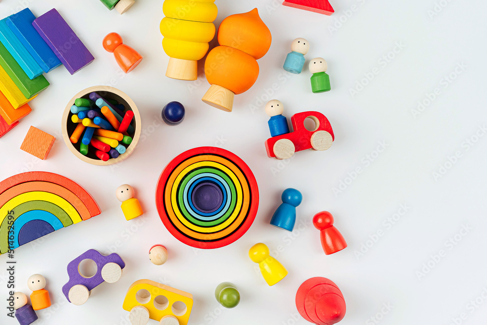 Colorful wooden toys in the colors of the rainbow on white background ...