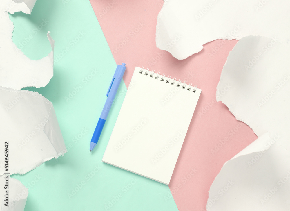 Pastel color trend. Notebook on a blue-pink background with torn paper ...