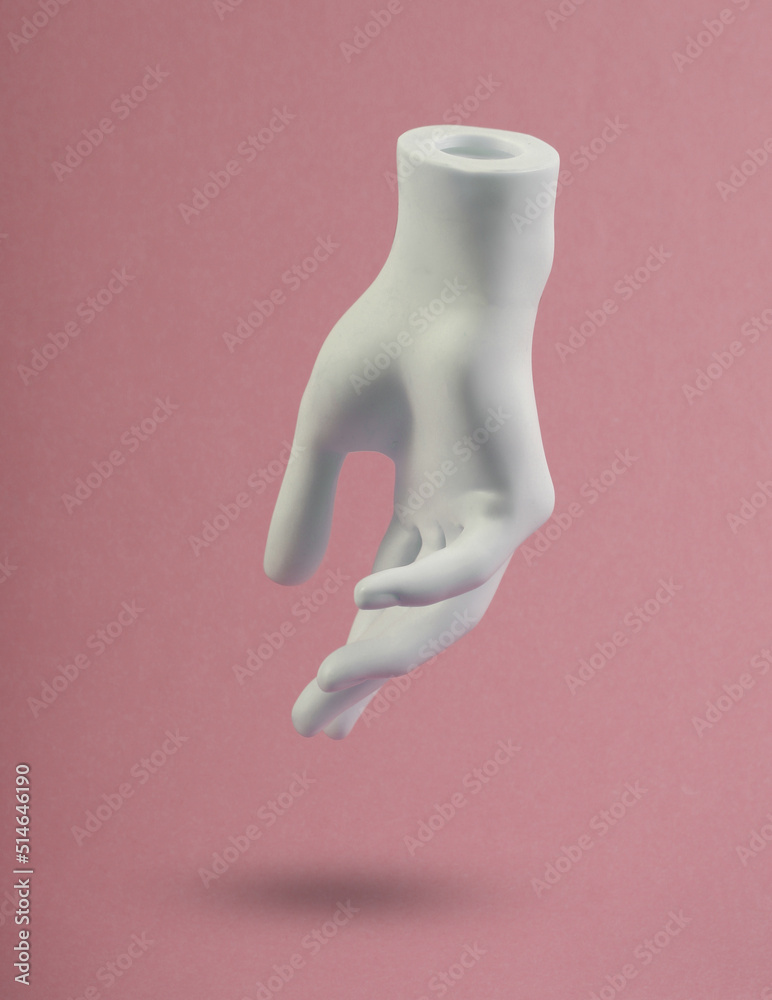 Mannequin hand floating in the air on a pink background. 3D photo ...