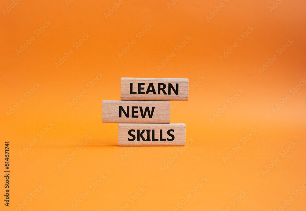 Learn new skills symbol. Concept words 'Learn new skills' on wooden ...