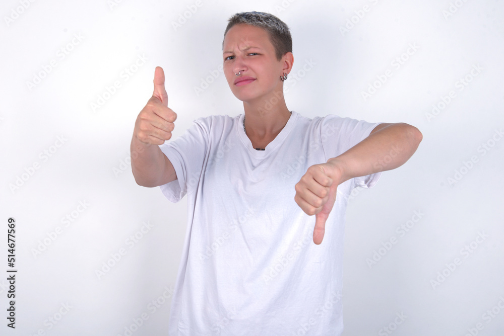 young woman with short hair wearing white t-shirt over white background ...