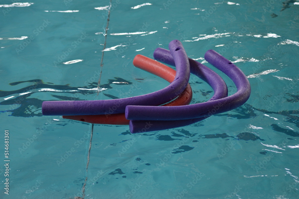 Three purple and one red swimming floating foam in the pool, equipment ...