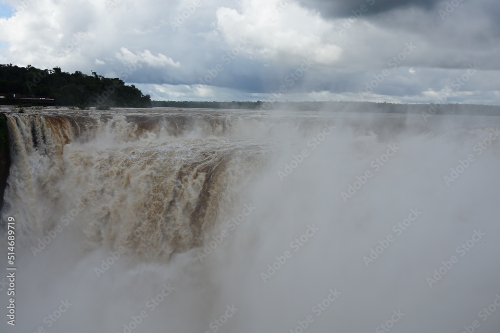 The photo shows a stunning view from the top of the Iguazu Falls — a ...
