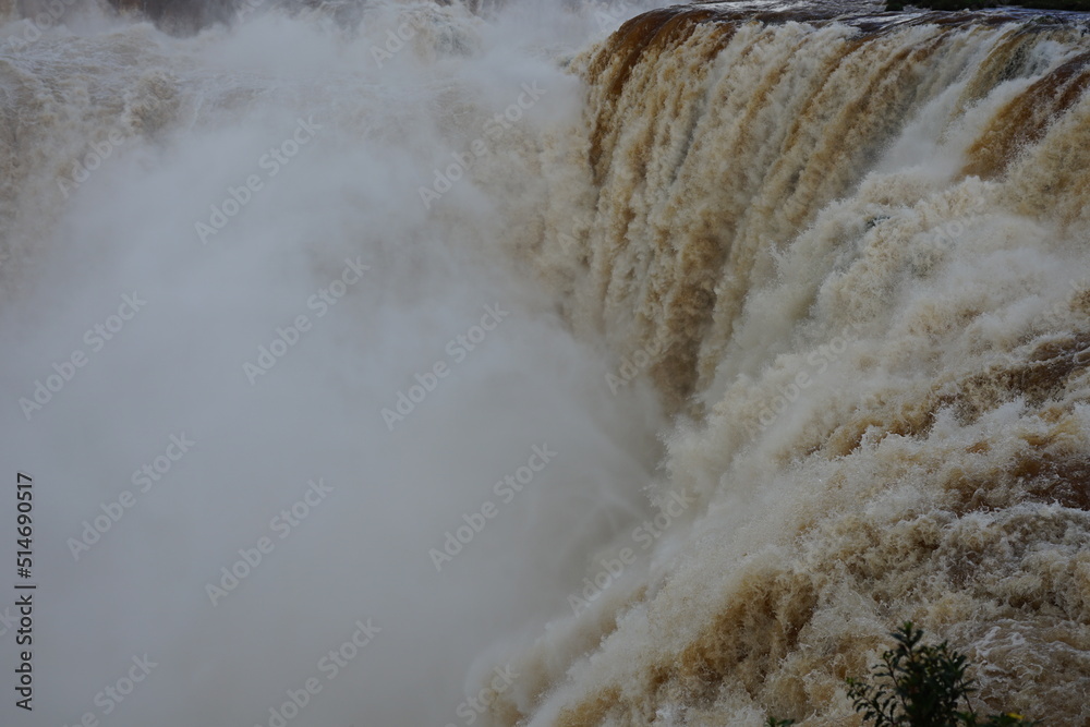 The photo shows a stunning view from the top of the Iguazu Falls — a ...