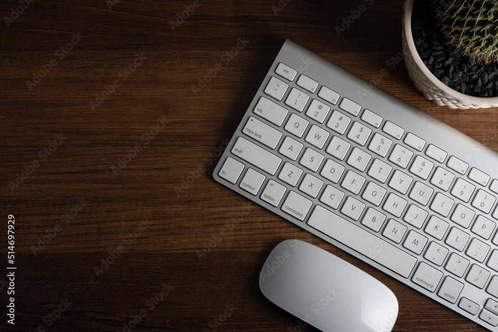 Brown Dark wood desk table with with wireless white computer mouse and ...