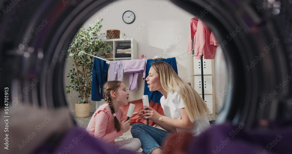 View from inside the washing machine drum into the laundry room. Mother ...