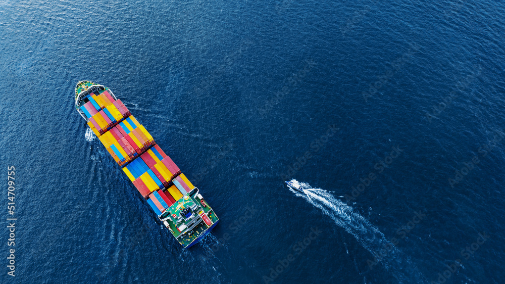 Aerial top view of cargo ship carrying container and running with Pilot ...