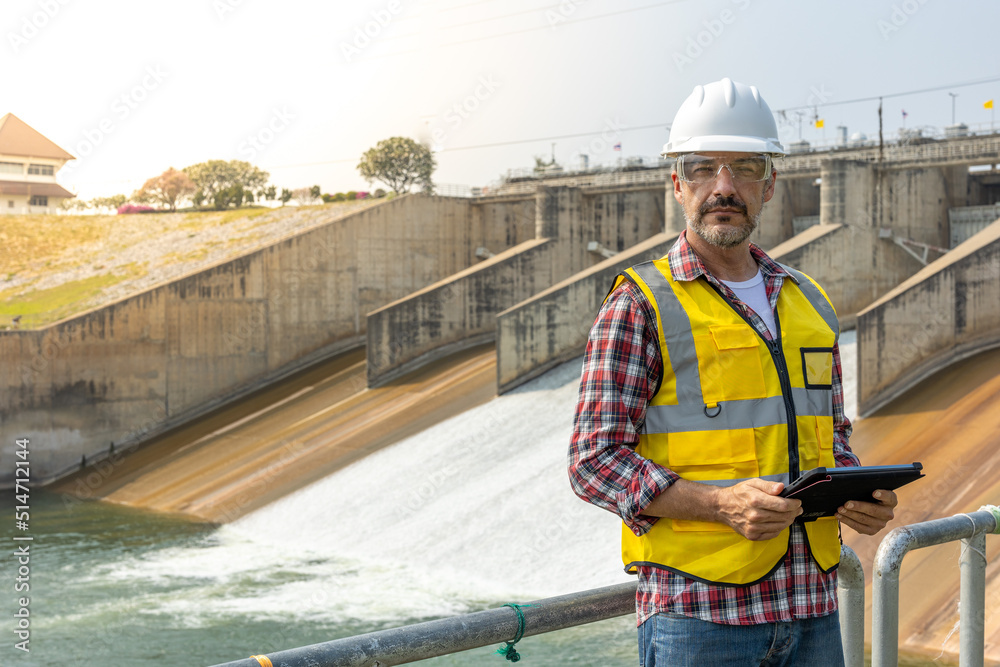 A dam engineering doing his checking routine. He is wearing a white ...
