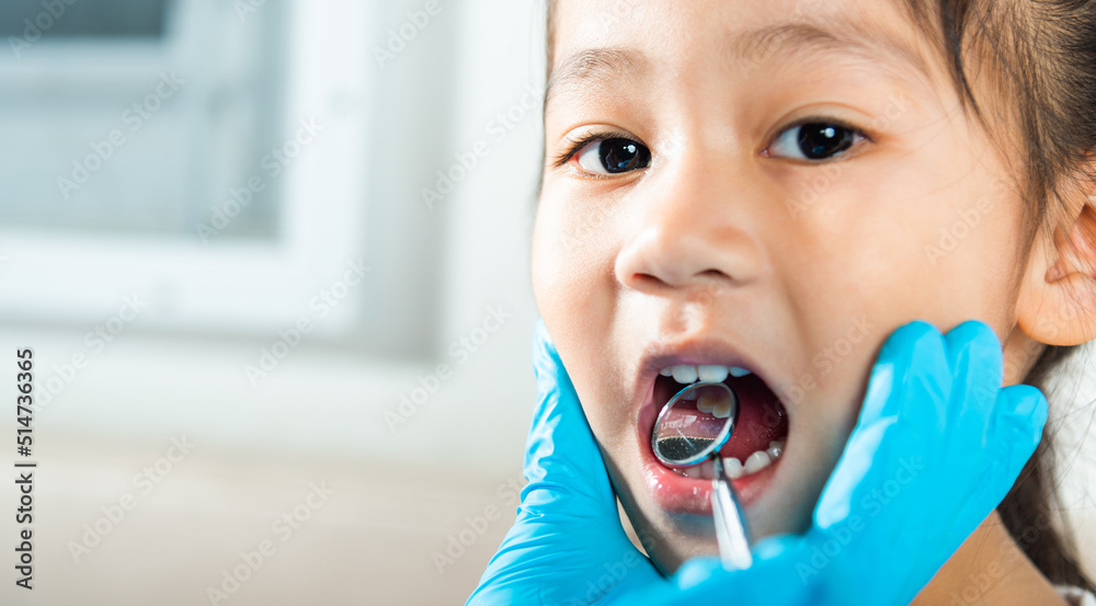 Dental kid health examination. Asian dentist making examination ...