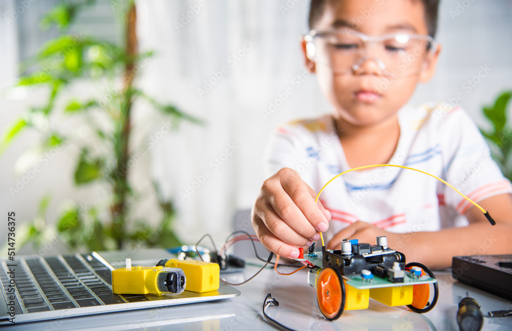 Little child remotely learn online with car toy before sent code, Asian ...