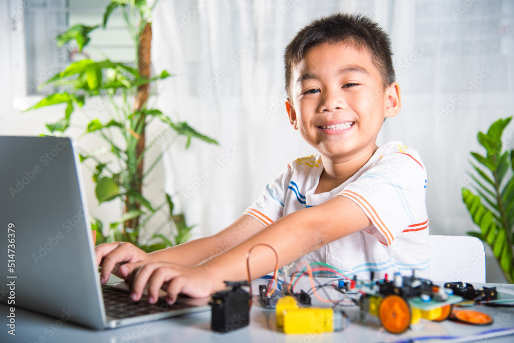 Asian kid boy learns coding and programming with laptop for Arduino ...