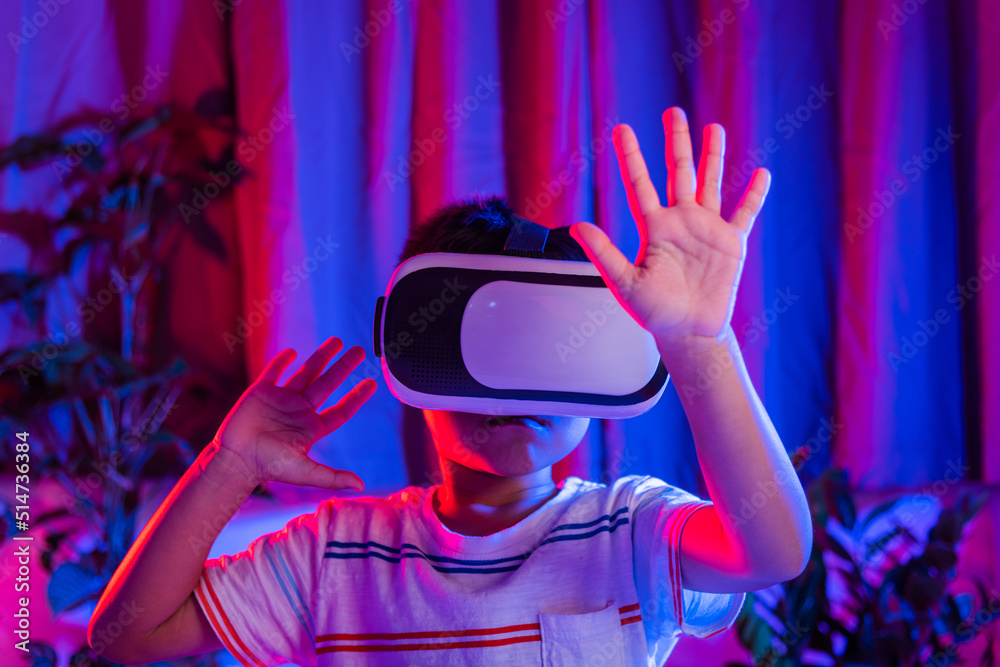 Little kid boy experiencing virtual reality goggles experiencing ...