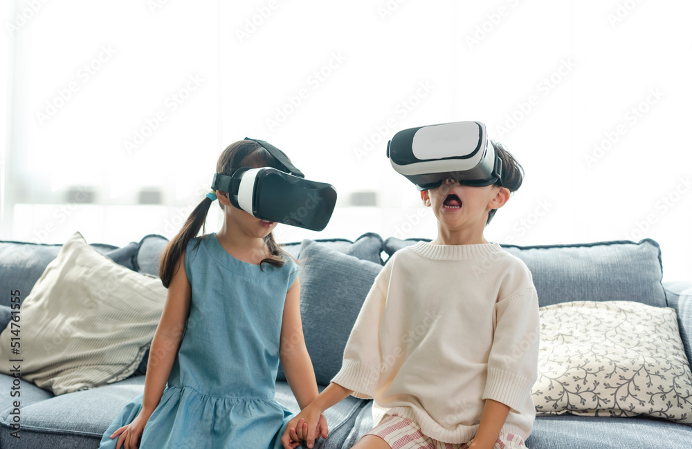 Asian child feeling excited while using 360 VR headset for virtual ...