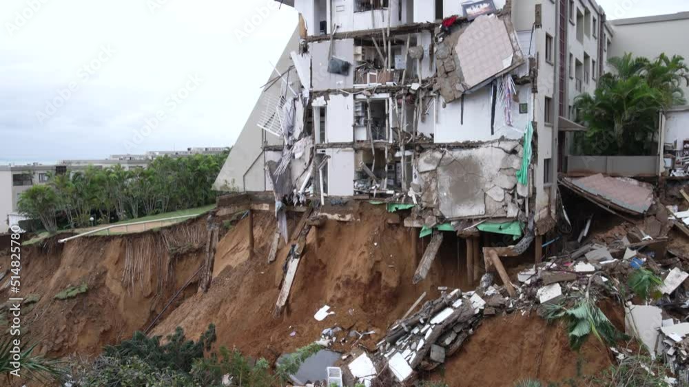 Pan from left to the destruction of an apartment building that has ...