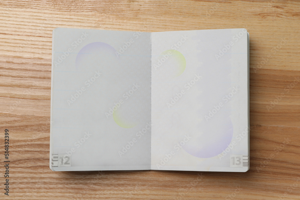 Blank open passport on wooden table, top view Stock Photo | Adobe Stock