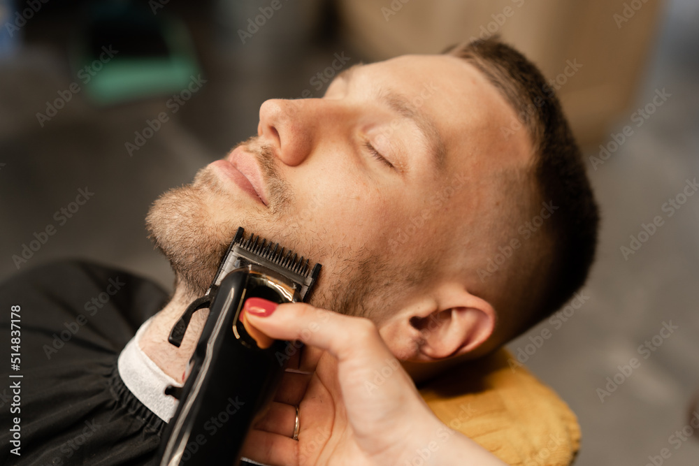Barbershop, close-up: woman barber shaves mans beard with a razor Stock ...