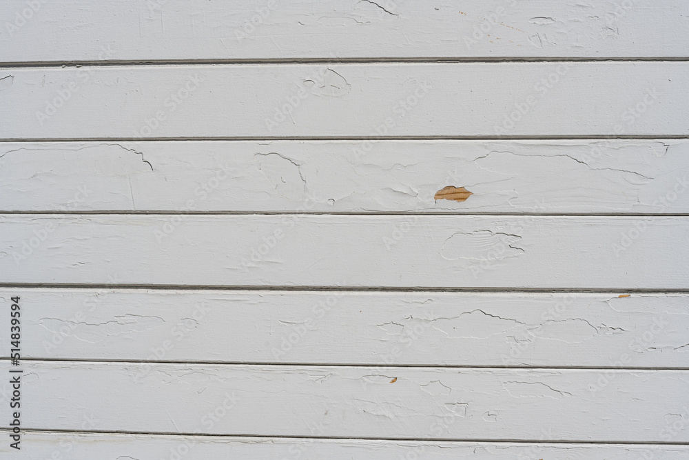 Dirty, old, blistered and flaking, repainted old white painted board ...