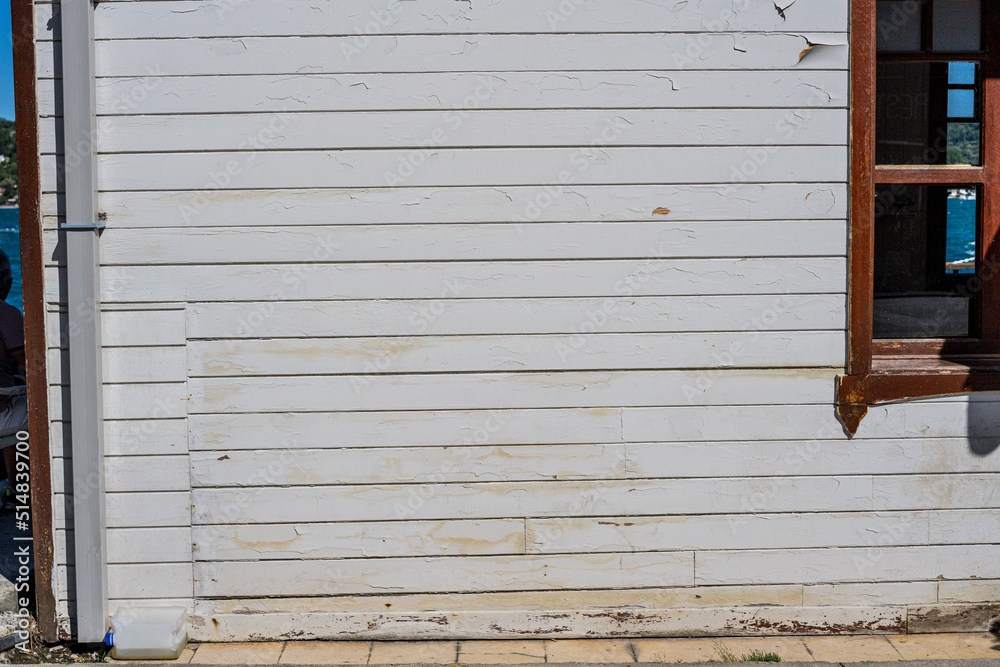 Dirty, old, blistered and flaking, repainted old white painted board ...