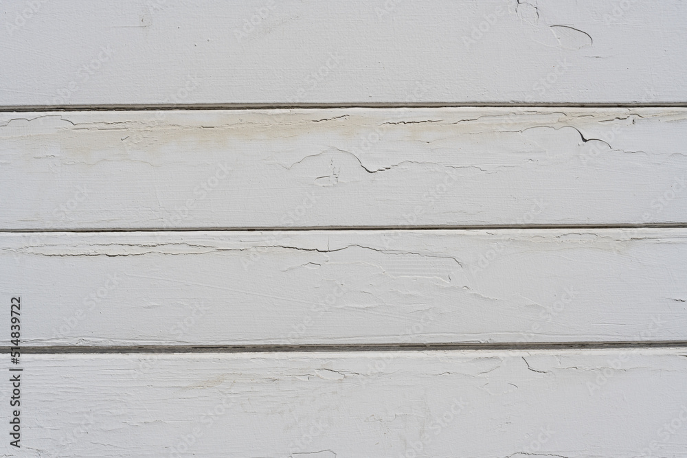 Dirty, old, blistered and flaking, repainted old white painted board ...