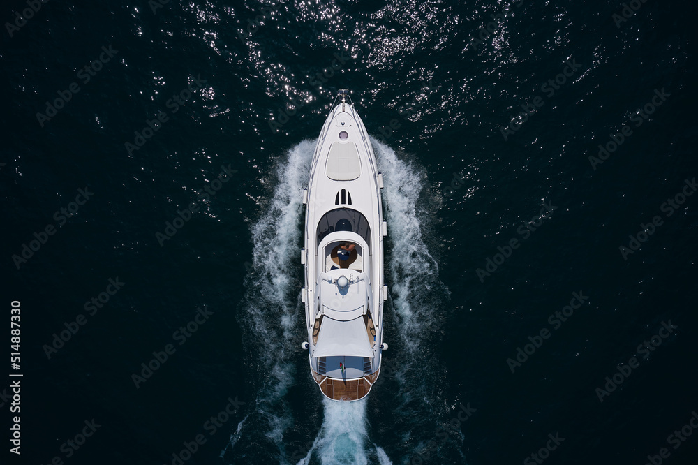 White yacht on the sea aerial view. Superyacht is moving fast on the ...