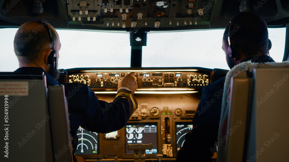 Diverse team of aviators preparing to takeoff with airplane, fixing ...