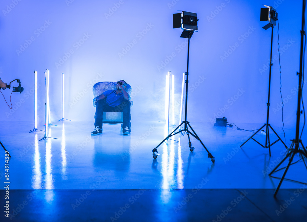 Singer sitting on chair filming at studio Stock Photo | Adobe Stock