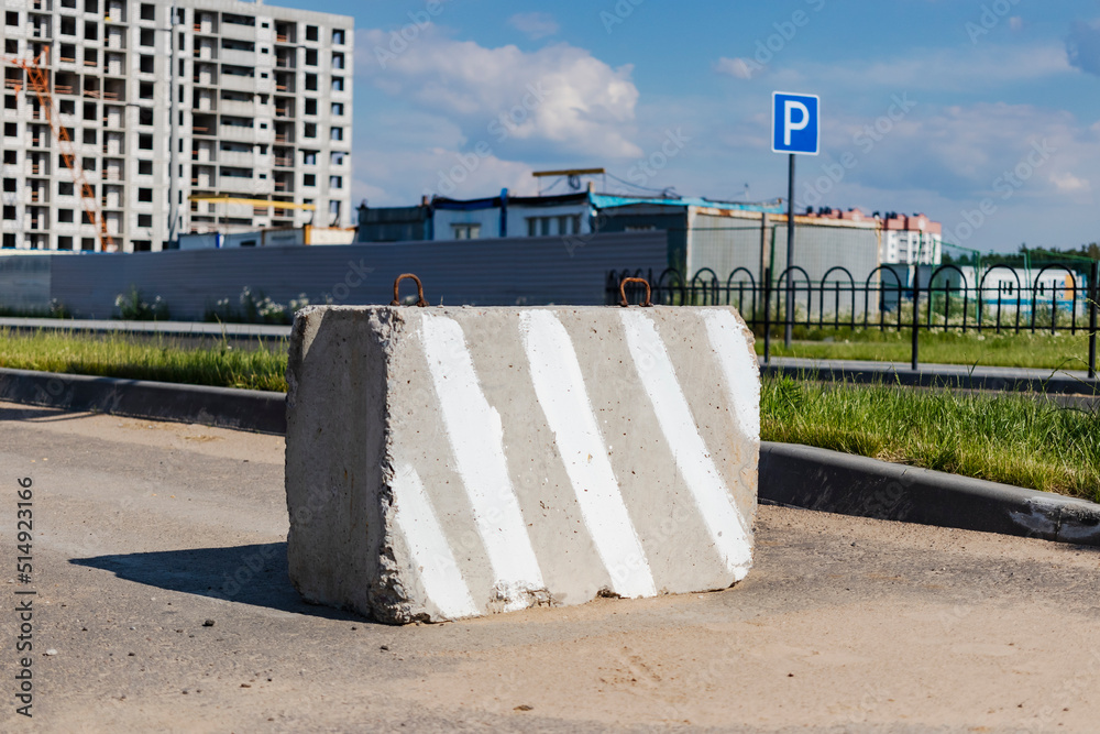 A stop road sign and concrete blocks block the entrance to the ...