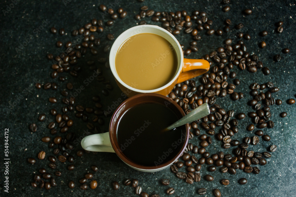 Two cups of coffee. Two flavors on black background. Top view. Stock ...