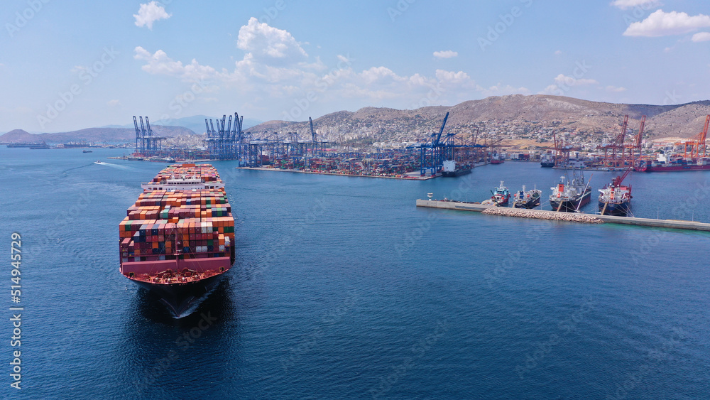 Aerial drone front view photo of huge container cargo ship leaving ...