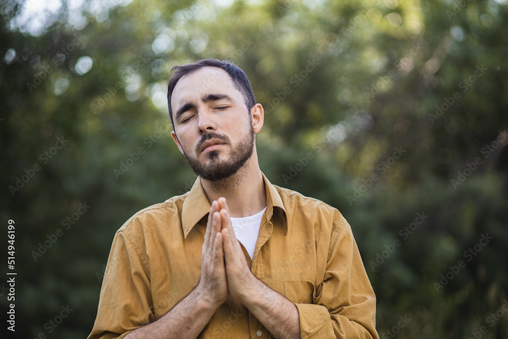The man is praying. Prayer to God. A man on the street prays for world ...