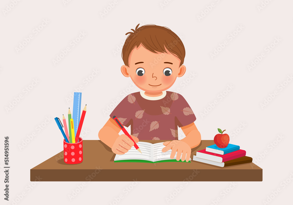 Cute little boy sitting on the desk studying writing on notebook doing ...
