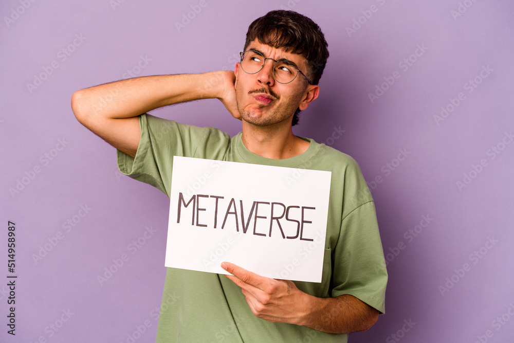 Young hispanic man holding meta verse placard isolated on purple ...