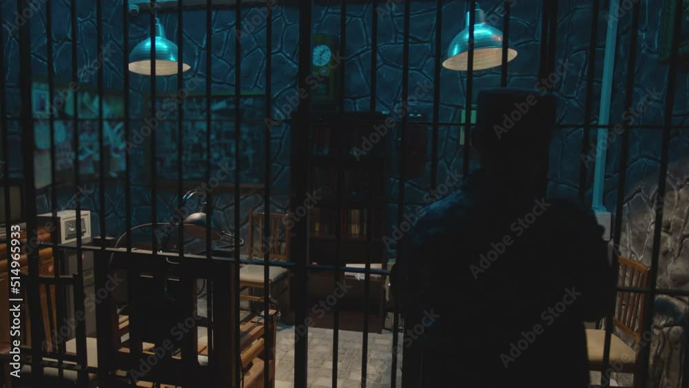 Dark jail cell at night . Hanging Swaying swinging lamps on dark room ...