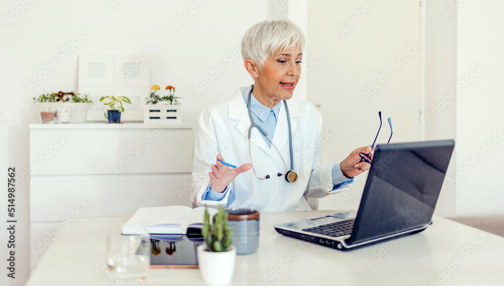 Female doctor from a medical clinic is having a video meeting with her ...