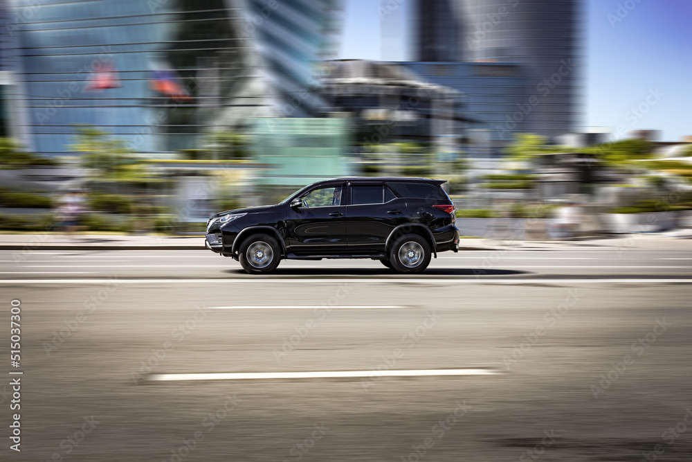 Side view rolling shot with Toyota Fortuner car in motion. Second ...