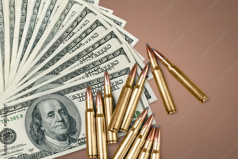 Cartridges with bullets in a bandolier, dollar bills. Concept: sale of ...