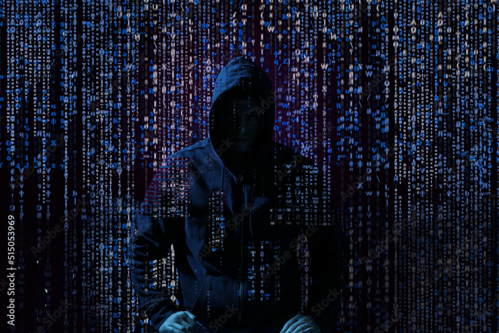 Silhouette of anonymous hacker and digital binary code on dark ...