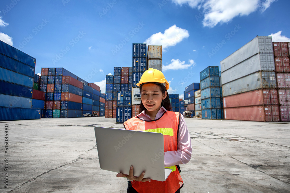 Foto de woman working with laptop in cargo container. Containers box ...