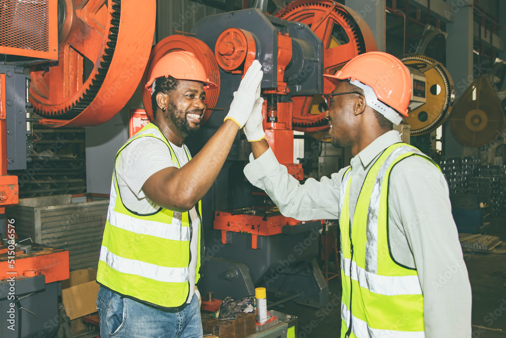 Teamwork working together two African American male workers honor high ...