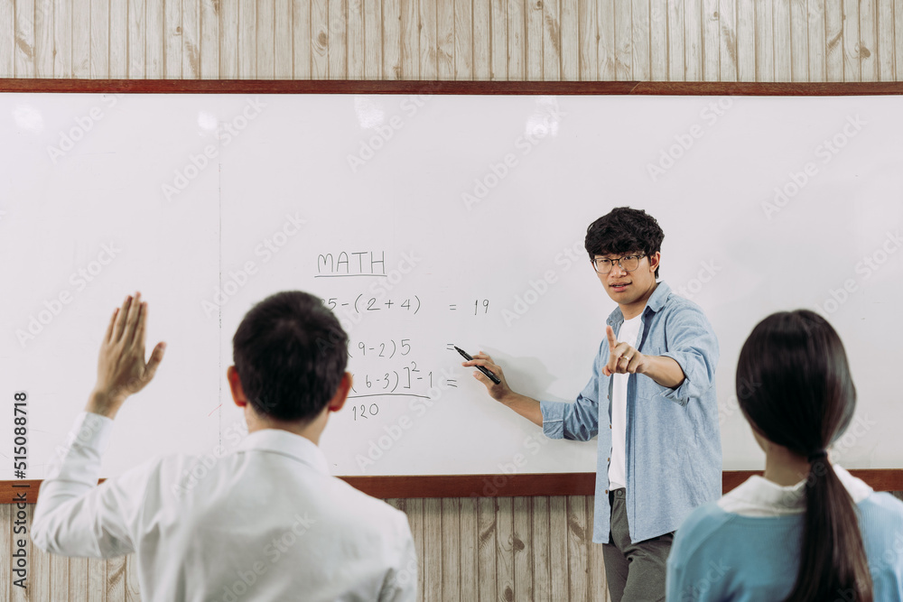Asian male teacher teaching students at the classroom Stock Photo ...