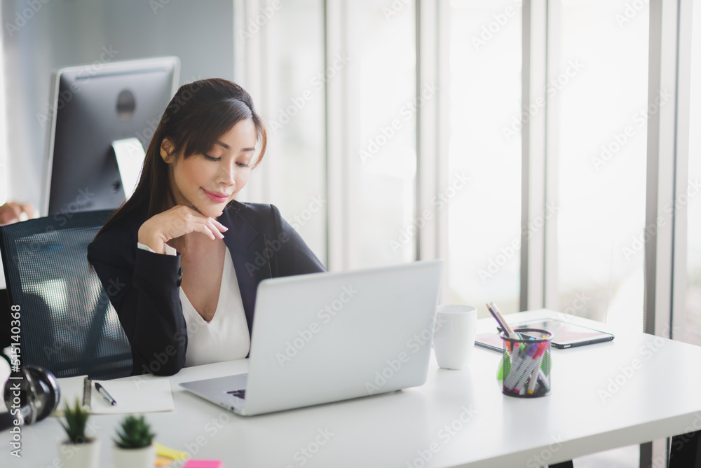 Business Asian woman working and typing in her laptop with smiling in ...